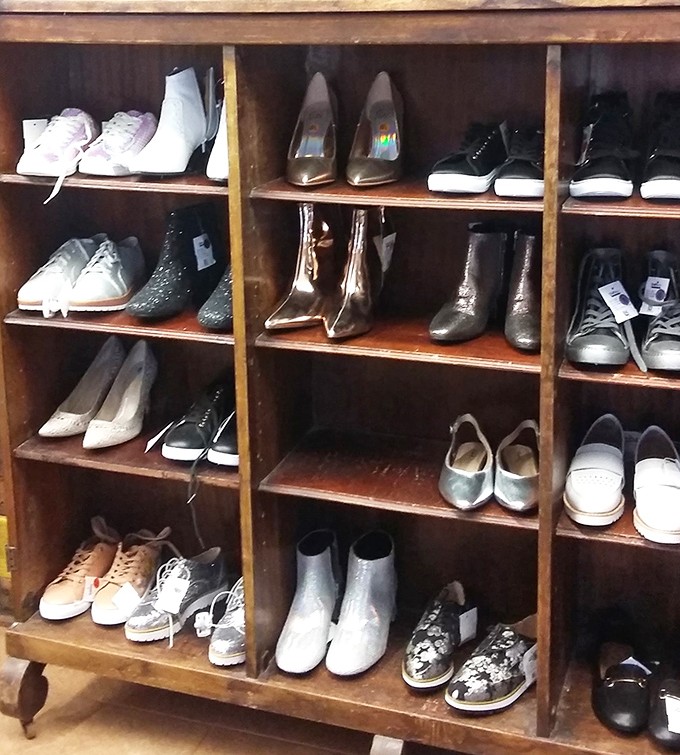 Wooden shelves cradle footwear treasures from practical flats to party-ready heels, all waiting for their Cinderella moment.