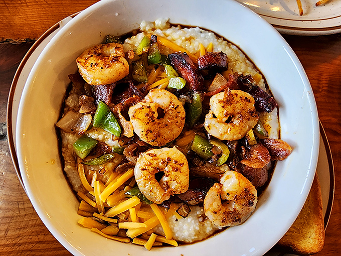 Shrimp and grits elevated to an art form &ndash; plump crustaceans lounging on a bed of cheesy goodness like they're at a five-star resort. 