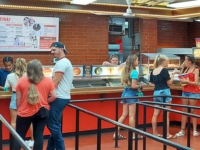 Concession stand lines move with practiced efficiency, as generations of moviegoers follow the time-honored tradition of loading up before showtime.