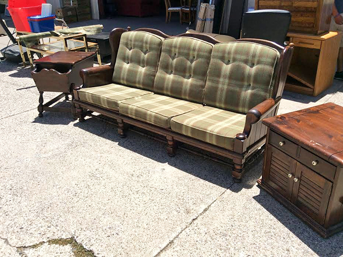 The plaid sofa that time forgot, yet somehow feels perfectly current. Mid-century comfort with a dash of "grandpa's den" charm.