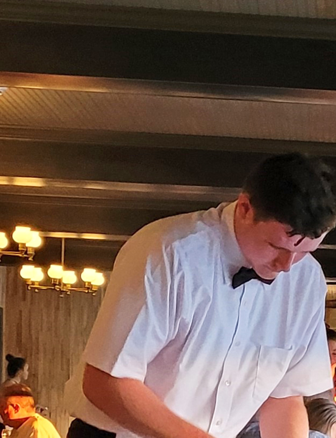 Behind every perfect seafood dish is a dedicated professional. The staff moves with the precision of a well-choreographed maritime ballet. 