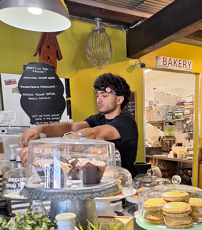 Behind every perfect pastry is a dedicated team member, carefully curating display cases that should come with a warning: "May cause spontaneous dessert decisions."