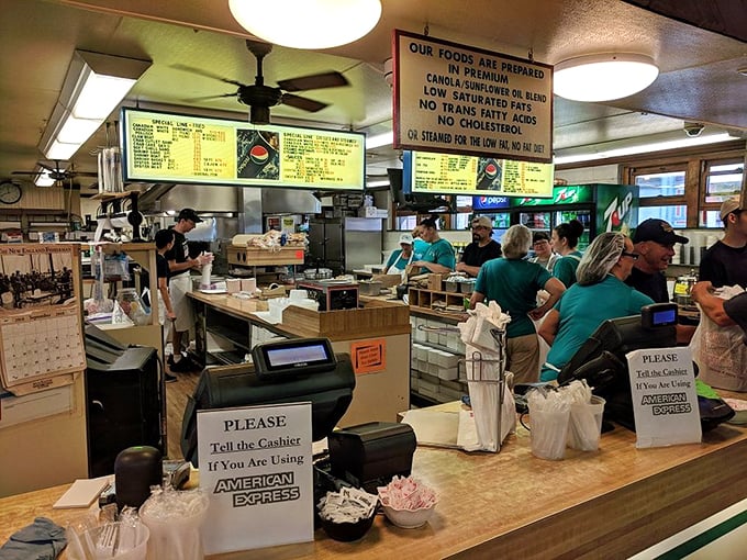The kitchen crew moves with the practiced efficiency of a ballet company that happens to specialize in perfectly fried seafood instead of pirouettes.