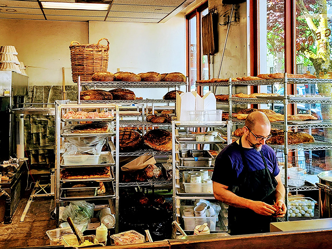 Behind the scenes, where the magic happens. Those racks of bread are like a library of flavor, each loaf telling its own delicious story.