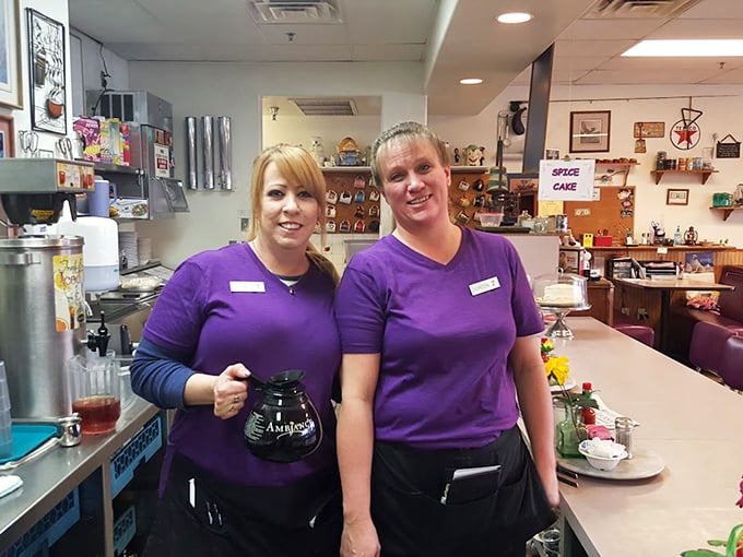 The heart of Lou's Diner: servers in purple shirts wielding coffee pots like magic wands, turning caffeine into morning salvation.
