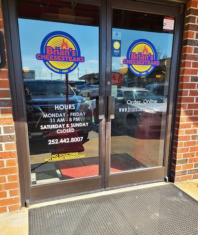 Business hours posted clearly&mdash;because knowing exactly when you can get your cheesesteak fix is information more valuable than gold.