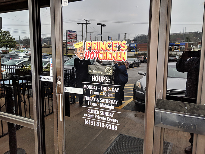 The hours posted clearly on the door&mdash;crucial information for planning your hot chicken pilgrimage. Note the weekend midnight closing&mdash;Nashville knows when spice cravings hit hardest.