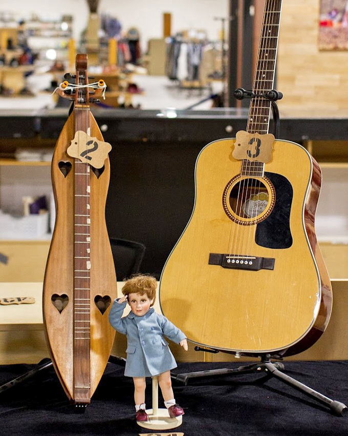 These string instruments flanking a vintage doll create an oddly charming trio&mdash;like finding the perfect band for your next imaginary parlor concert.