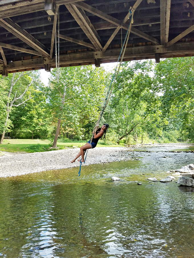 The bridge's unofficial summer amenity: a rope swing that turns Dunlap Creek into Virginia's most historically significant swimming hole.