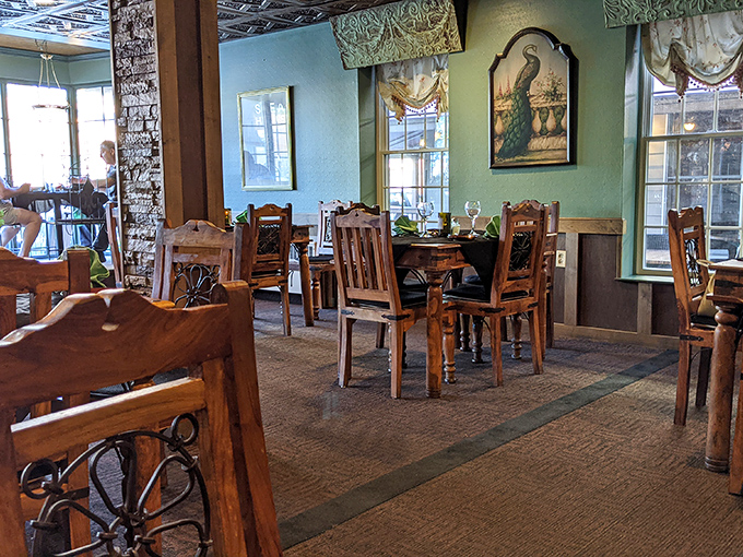 Dining room where peacock artwork and ornate mirrors create an atmosphere that's equal parts elegant and comfortable.