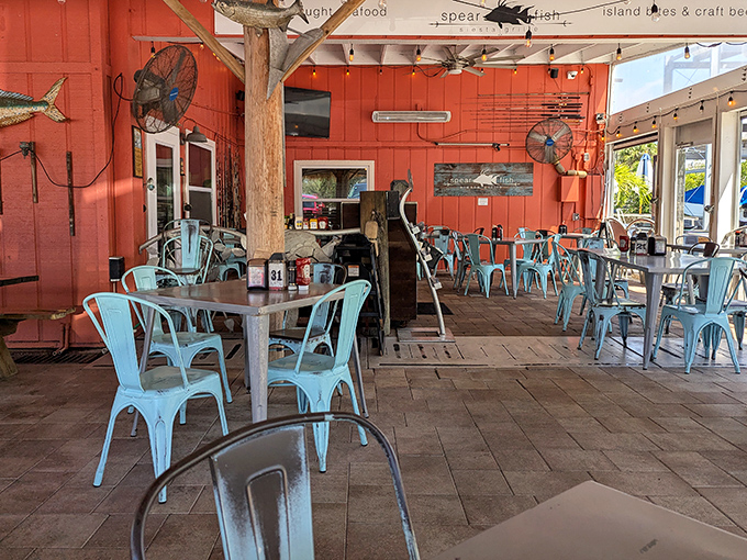 Turquoise chairs and wooden tables create that effortless beach vibe interior designers charge thousands to replicate poorly.