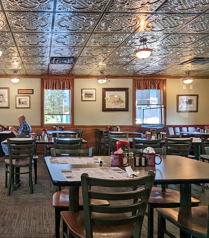 Empty tables waiting for their next guests, beneath the ornate tin ceiling that's witnessed countless celebrations, first dates, and Sunday family gatherings.