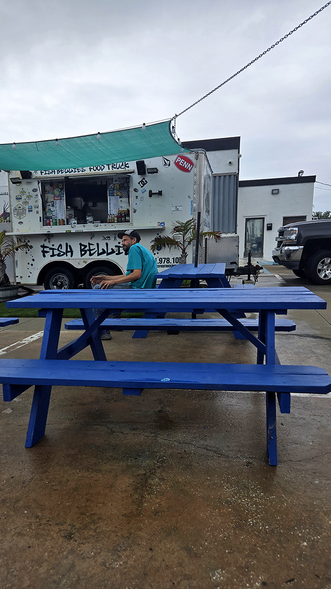 Blue picnic tables await hungry patrons. In Florida's dining scene, sometimes the best seats come with no reservations required.