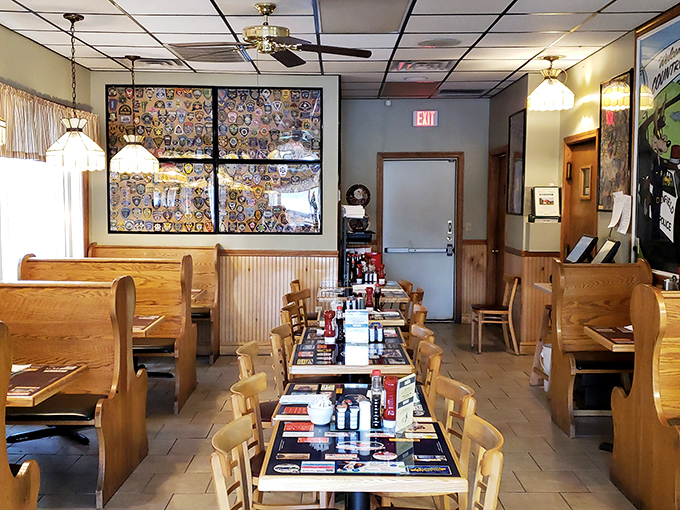 Wooden booths lined up like soldiers, ready for the breakfast rush. Those placemats have witnessed countless coffee refills and life-changing conversations.