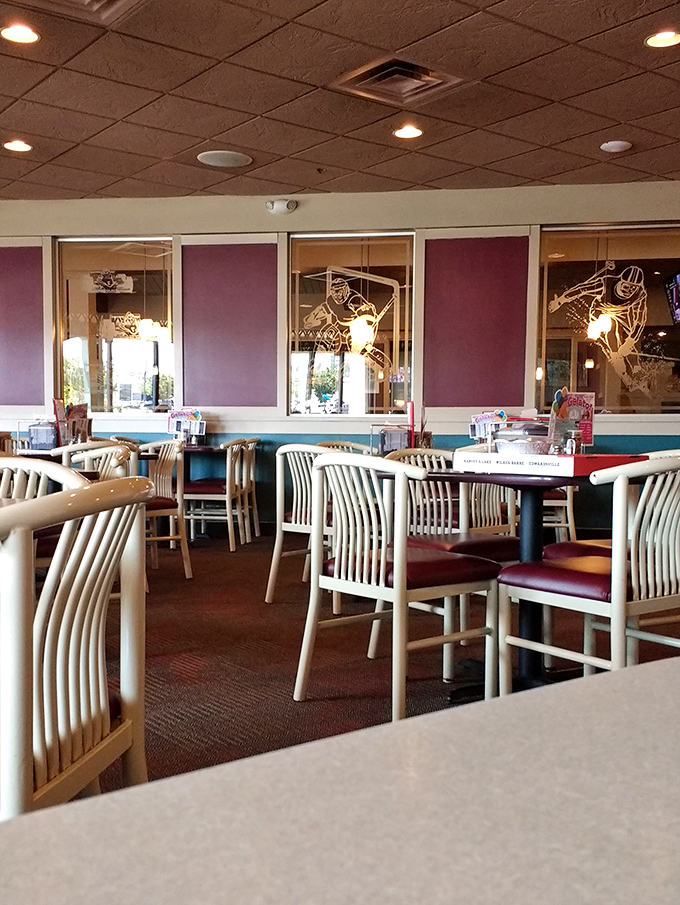 Empty tables that won't stay that way for long. The sports-themed etched glass dividers remind you that in Pennsylvania, food and fandom go hand in hand.