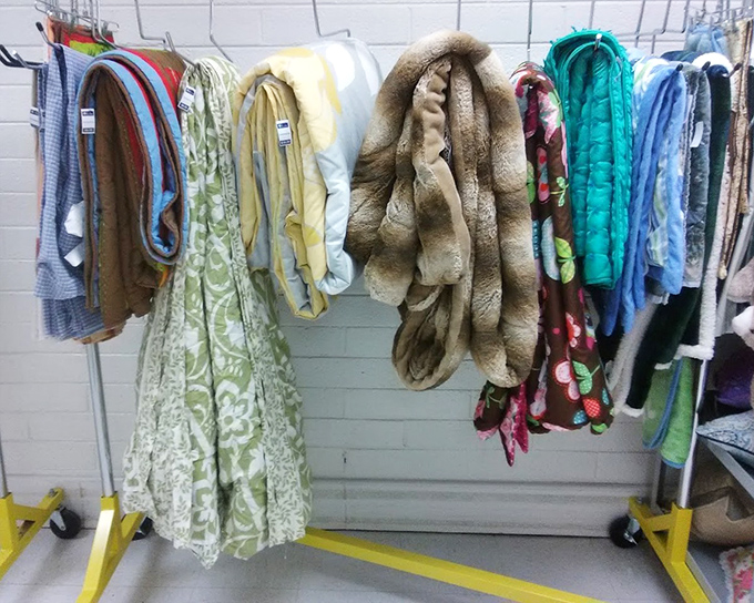 The textile section: where grandma's curtains and tomorrow's craft project materials live side by side. That fur throw has stories it's dying to tell.