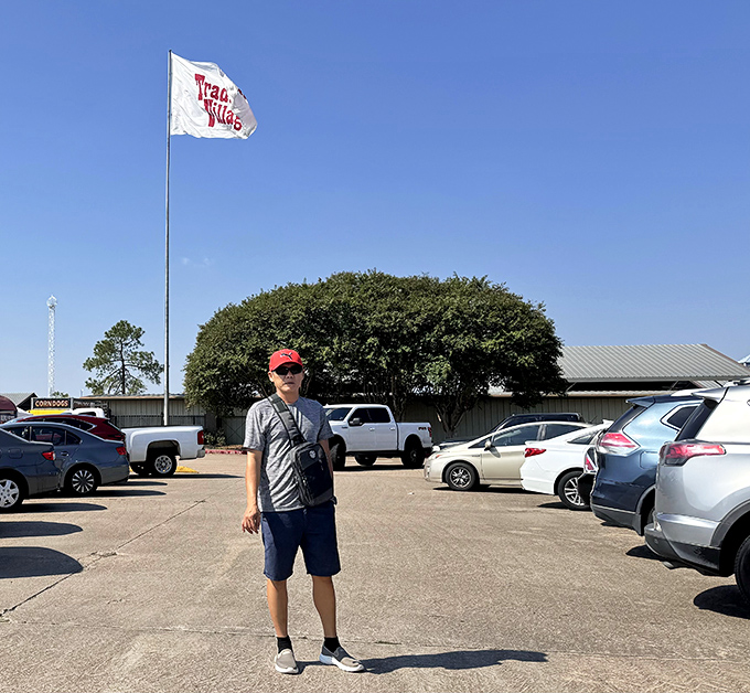 Shopping satisfaction personified! Under the Traders Village flag, this explorer has conquered the marketplace and lived to tell the tale.