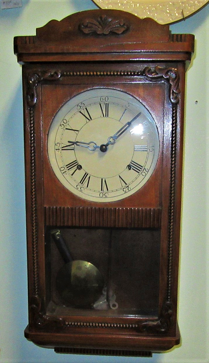 Time literally stands still in this handcrafted wooden clock, its pendulum waiting for someone new to wind its springs and bring its tick-tock back to life.
