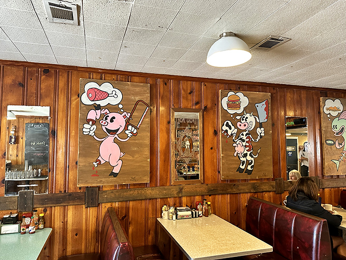 Whimsical cartoon murals add playful charm to the wood-paneled walls, making every meal feel like a nostalgic escape.