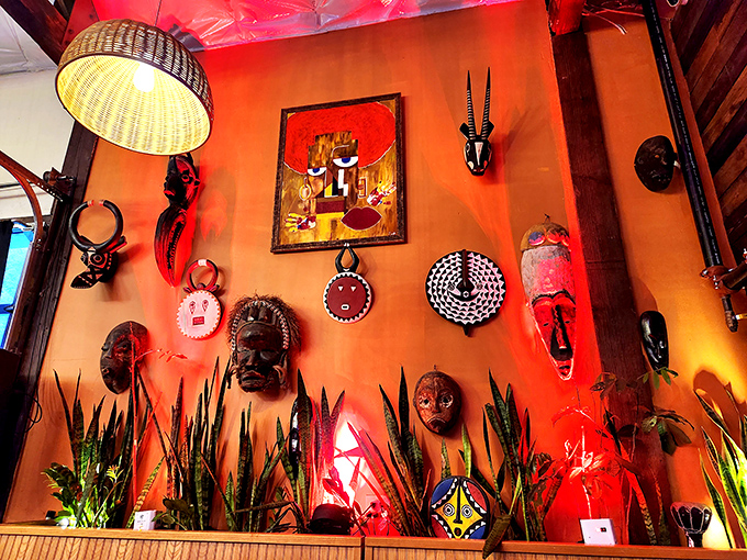 Traditional African masks and art transform a wall into a cultural gallery &ndash; dinner with a side of visual storytelling.