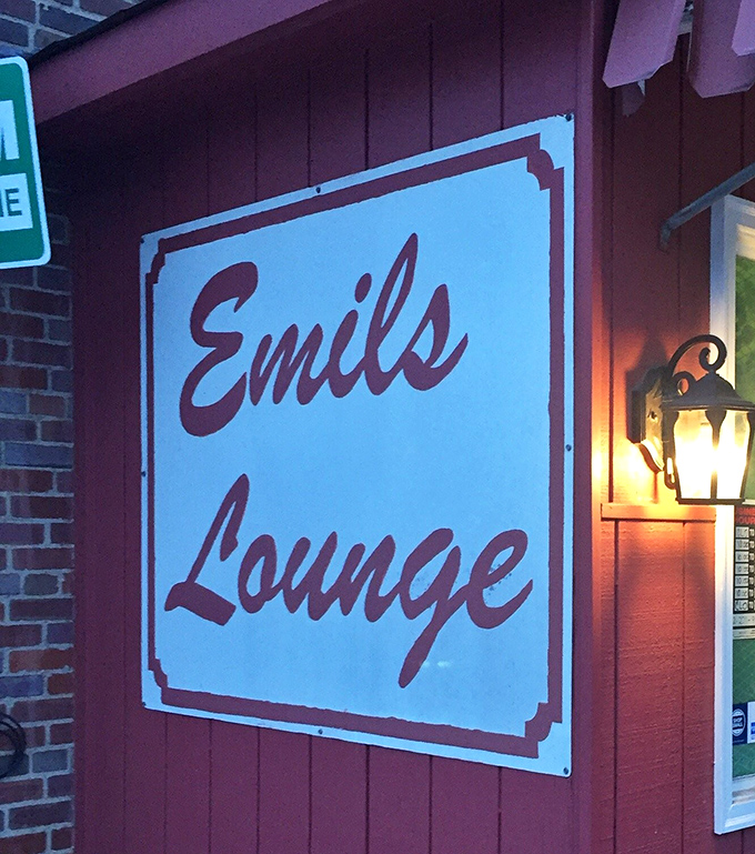 The sign promises "Lounge" but delivers "Institution"&mdash;Emil's name glows with the confidence of a place that knows exactly what it is.