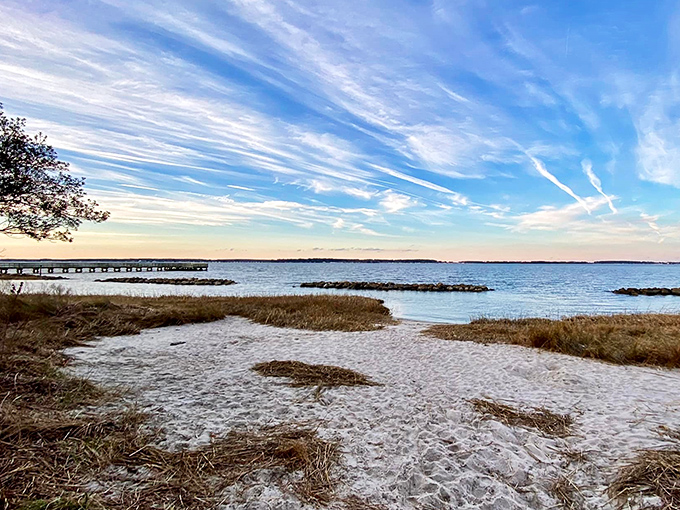 Where land meets bay, a simple stretch of sand becomes the border between everyday life and the promise of aquatic adventure.