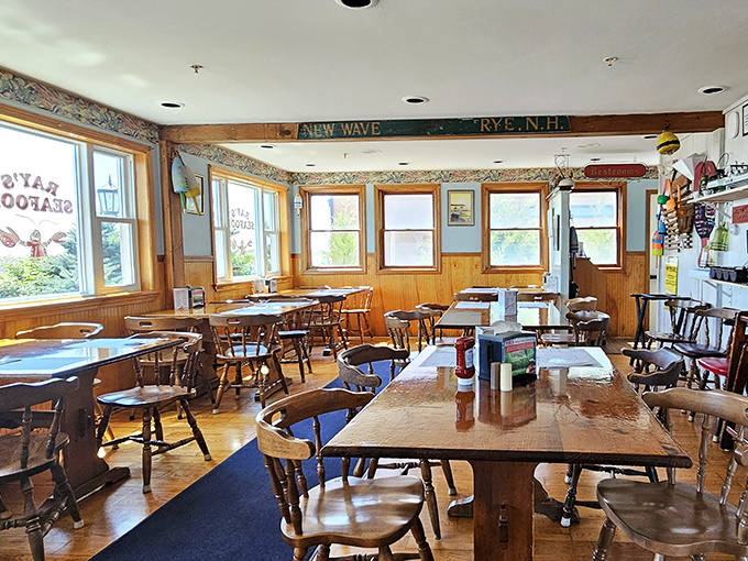 Sunlight streams through windows in this bright dining area, where wooden chairs have shaped themselves to fit generations of seafood lovers.