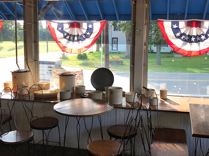 Patriotic bunting frames windows overlooking peaceful rural roads where rush hour simply doesn't exist in anyone's vocabulary here.