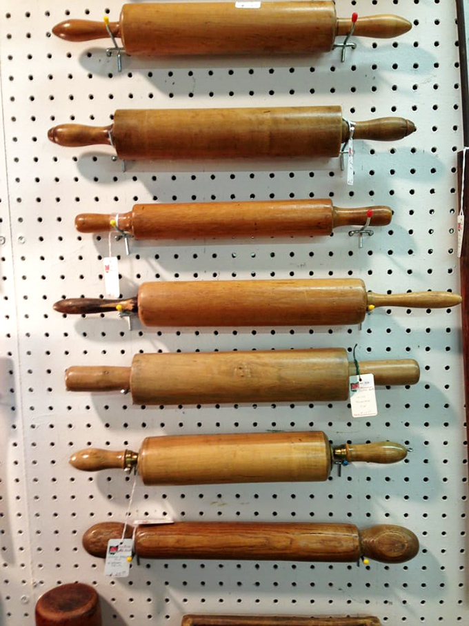 Rolling pins with stories baked in. Each one kneaded dough for countless pies before retiring to this pegboard display.
