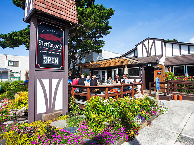 Driftwood's Tudor-inspired entrance surrounded by flowers creates a storybook welcome to this Cannon Beach classic.