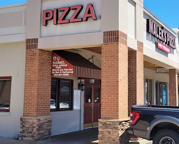 Malek's straightforward storefront with that bold "PIZZA" sign cuts right to the chase &ndash; no frills, just thrills for your taste buds.