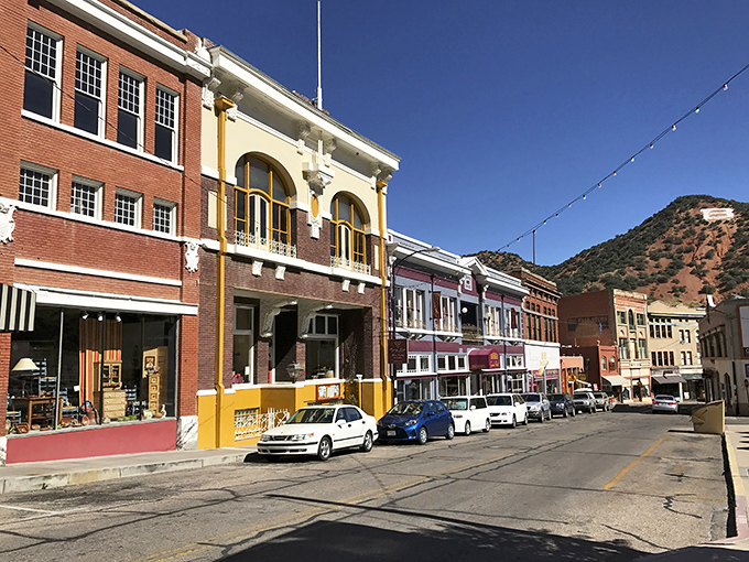 The historic buildings of Bisbee stand shoulder to shoulder, their varied facades creating a timeline of architectural styles against the mountain backdrop.