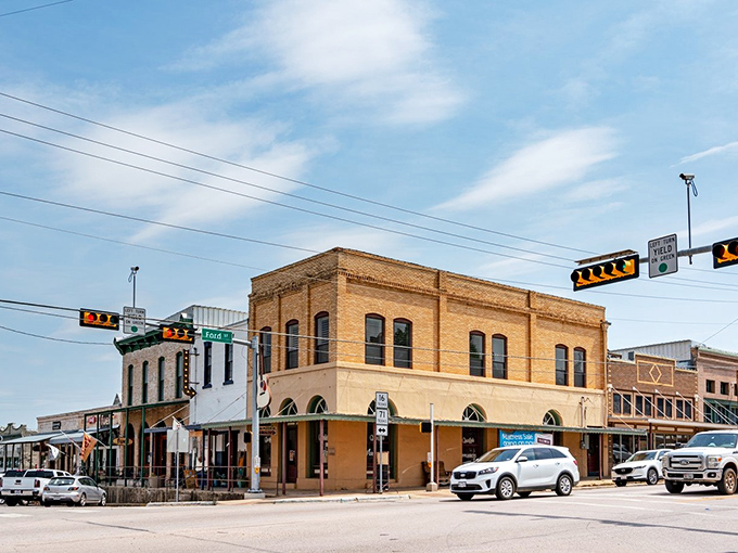 The sandstone buildings of Llano stand proudly along the main street, their warm colors glowing in the Texas sunshine.