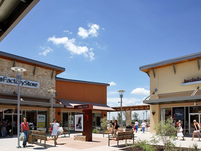 Covered walkways create shopping comfort, where Texas heat meets climate-controlled retail therapy in perfect harmony.