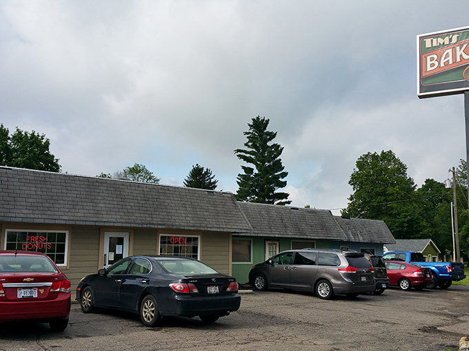 Misty morning at Tim's Bakery, where the illuminated sign guides hungry travelers like a lighthouse for sweet-seekers.