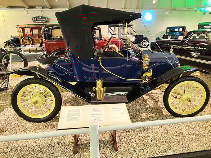 This navy blue 1912 Flanders 20 Touring Car, with its brass accents and spoked wheels, epitomizes early automotive elegance and engineering simplicity.