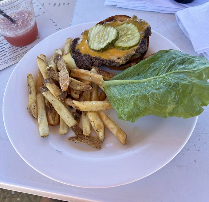 The American cheeseburger &ndash; proof that sometimes the classics endure for good reason. Those seasoned fries are the supporting actors who steal the scene.