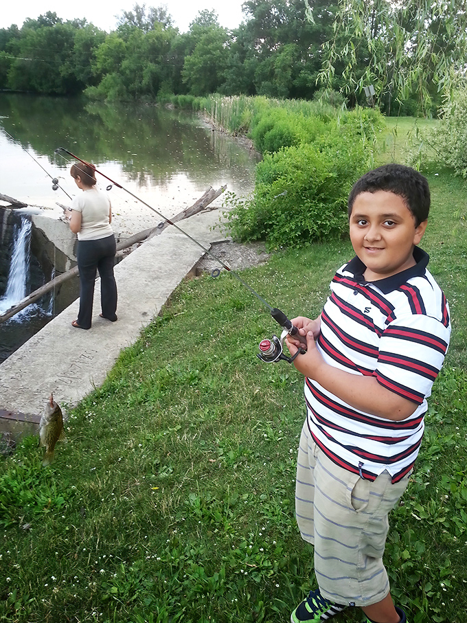 Fishing at the park is a multigenerational affair. That proud smile says, "First catch of the day!" louder than words ever could.