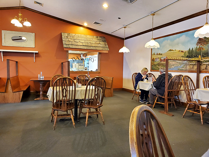 Warm orange walls and rustic touches create dining spaces that feel like you're eating in someone's well-loved country home rather than a restaurant.