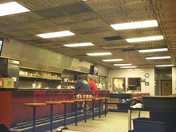 The diner's heartbeat: red counter stools, vintage ceiling tiles, and the promise of coffee refills as reliable as sunrise.