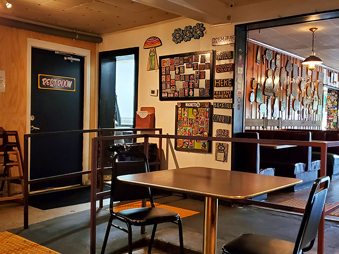 Another dining nook showcases more of the eclectic wall art that makes eating here feel like dining in a gallery of Southern food appreciation.