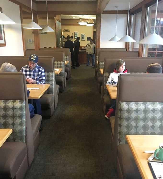 Cozy booth seating creates intimate dining islands where conversations and coffee flow freely&mdash;the quintessential American diner experience.