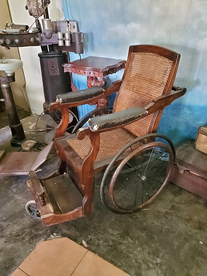 This antique wheelchair tells tales of early healthcare innovation, looking simultaneously medieval and surprisingly sophisticated.