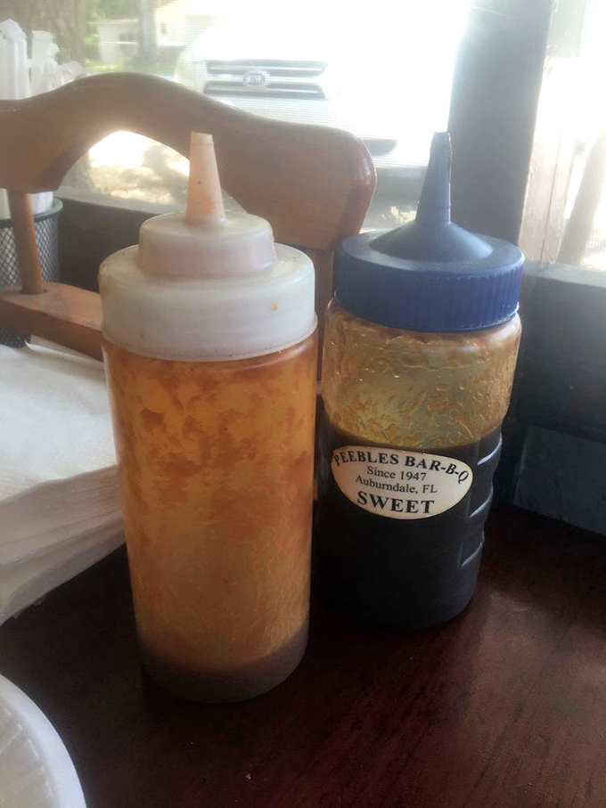 The house sauces - one tangy, one sweet - standing ready to enhance but never overshadow the star of the show: the meat.