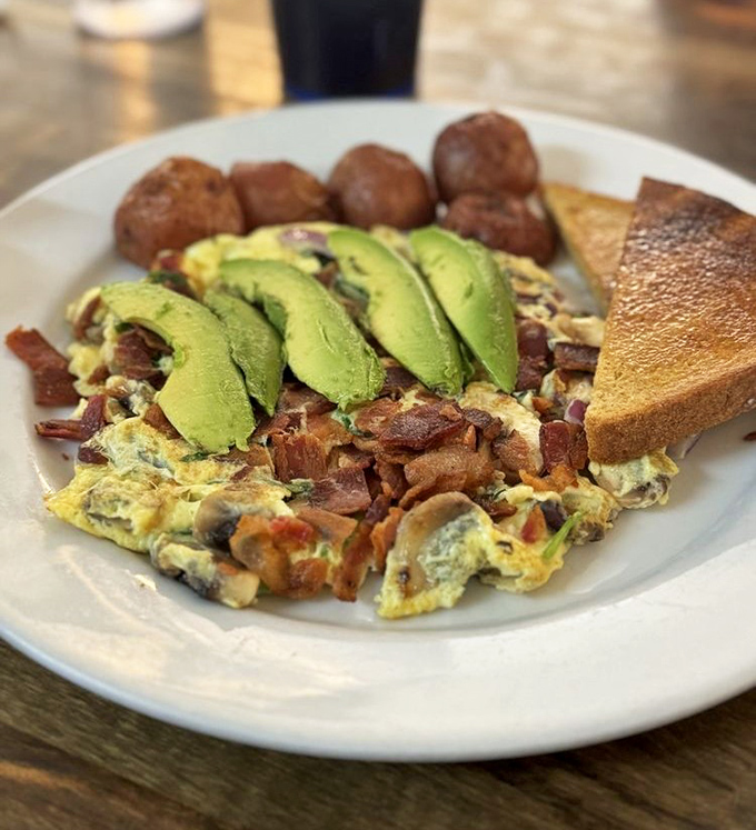 An omelet that's having a party and invited bacon, mushrooms, and avocado—the kind of breakfast that makes you cancel lunch plans.