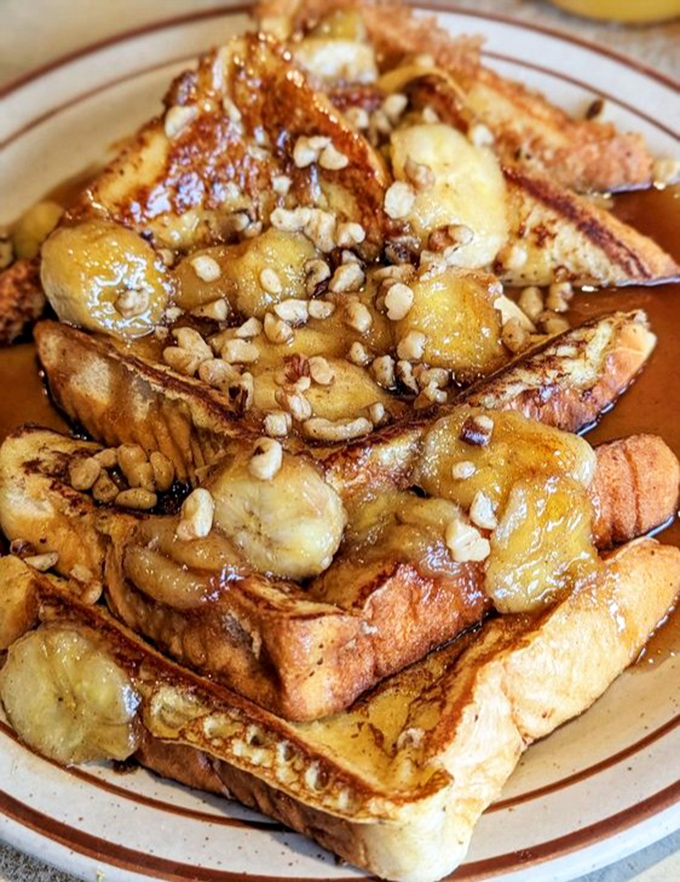 Bananas Foster French Toast loaded with caramelized bananas and nuts, making dessert-for-breakfast socially acceptable since forever.