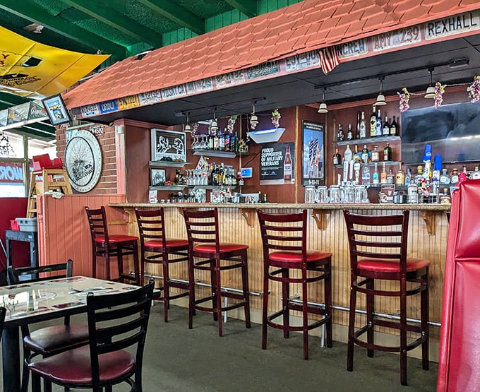 The bar area offers a front-row seat to diner theater, where coffee mugs clink and regulars hold court. Those red bar stools have supported generations of hungry patrons.