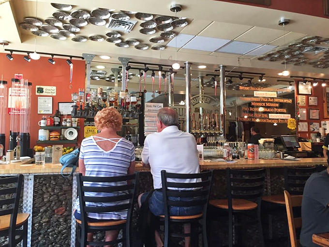 The bar area, where beer aficionados gather to discuss hop varieties and malt profiles with the same intensity others reserve for fine wine.