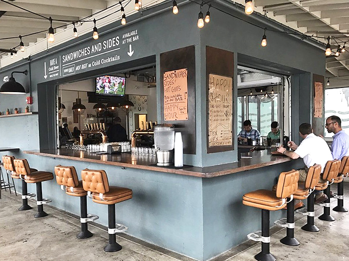 The bar at Lewis doesn't just serve drinks; it serves salvation from the Charleston heat and the perfect companion to smoked perfection.