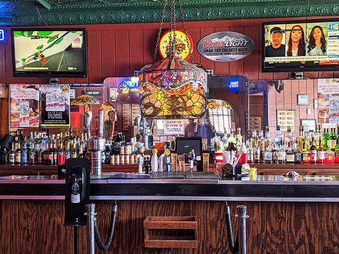 The bar area glows with stained glass warmth, offering libations that pair perfectly with paprika-spiced everything and televised Toledo pride.